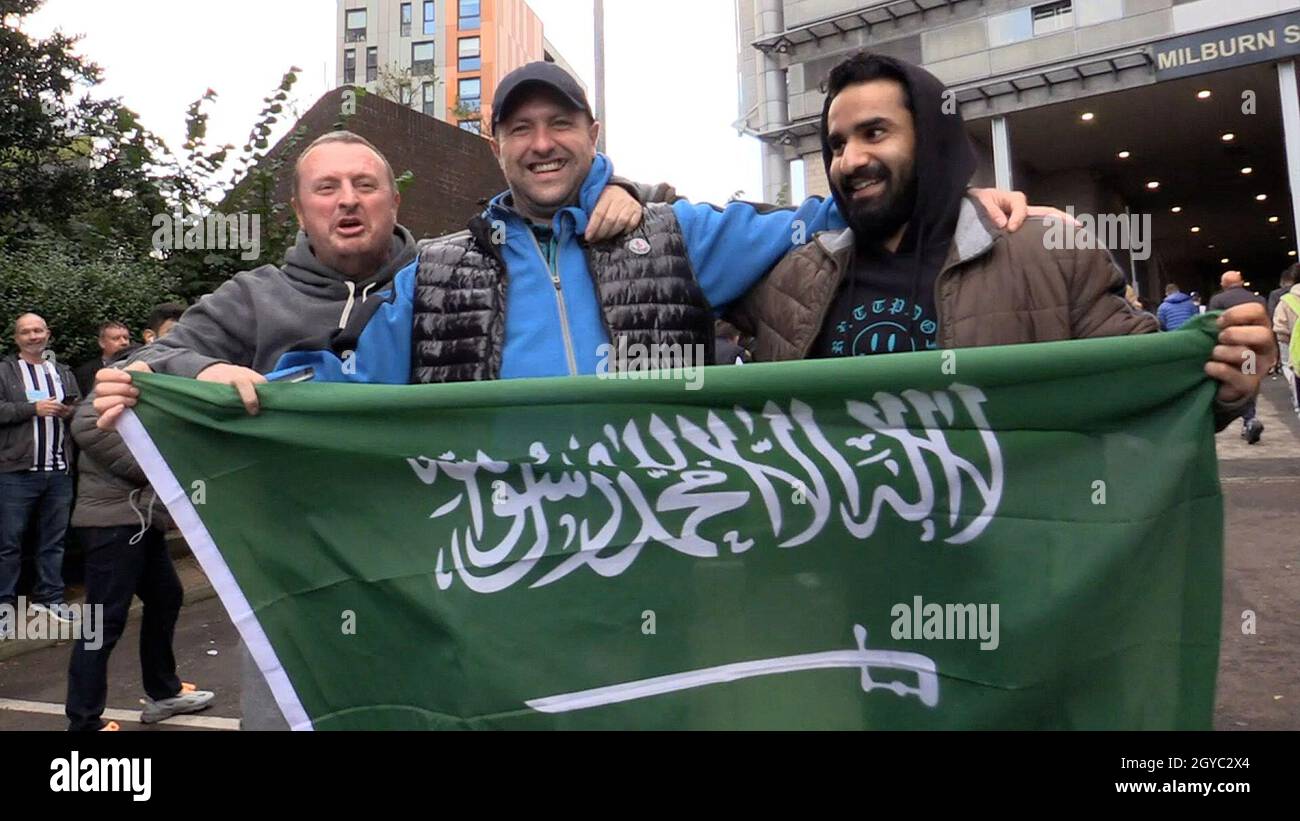 BEST QUALITY AVAILABLE Jubilant Newcastle United fans hold a Saudi flag ...