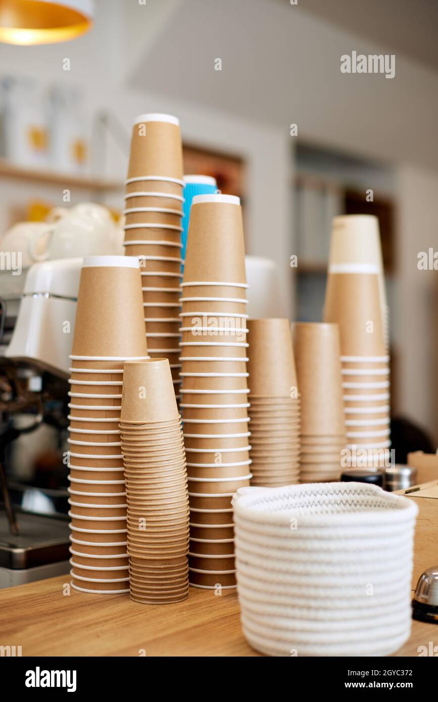 lot of drinking disposable paper cups in piles. stack of paper cup in ...