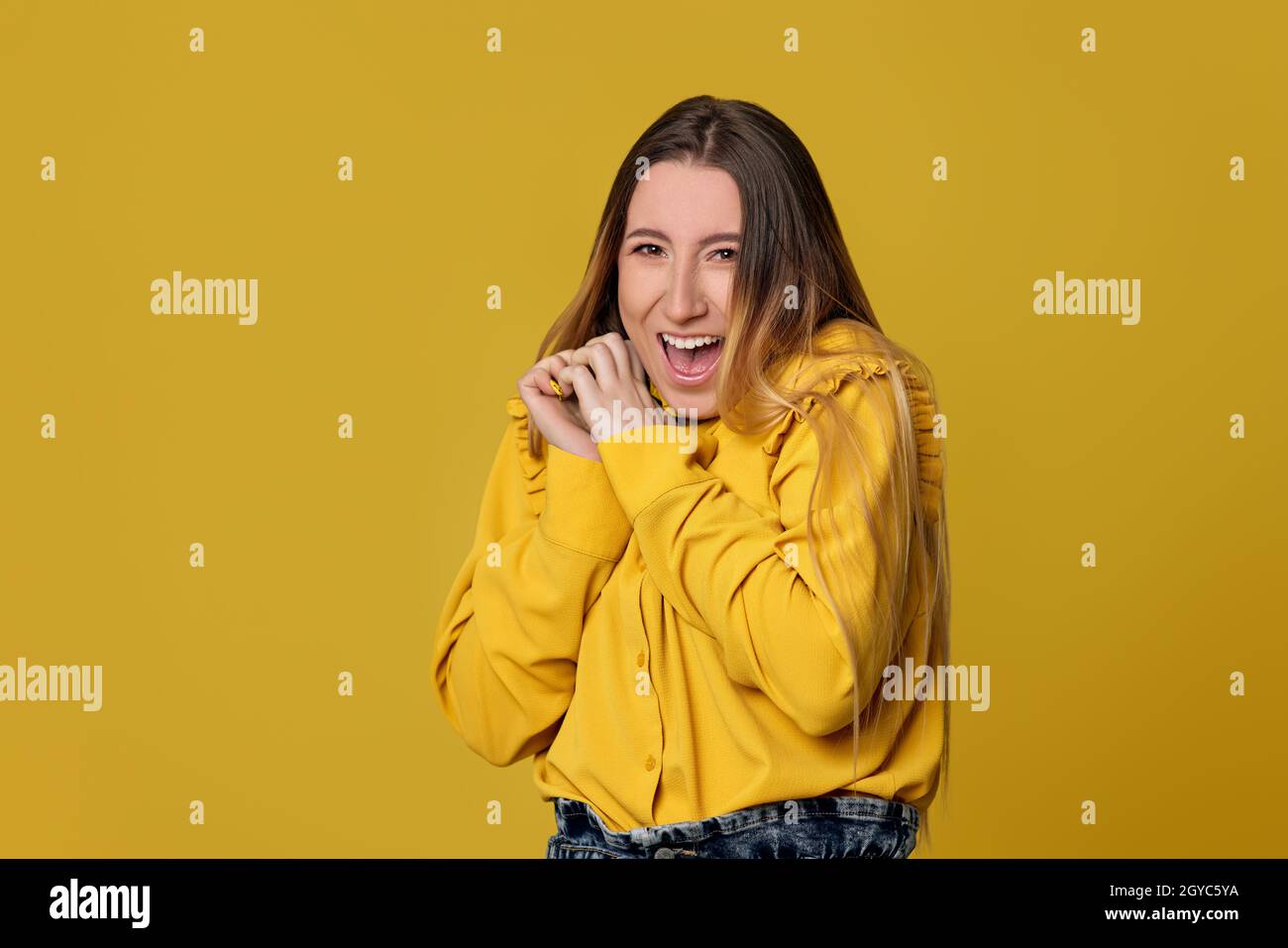 happy woman on yellow background. girl is expecting a pleasant surprise ...