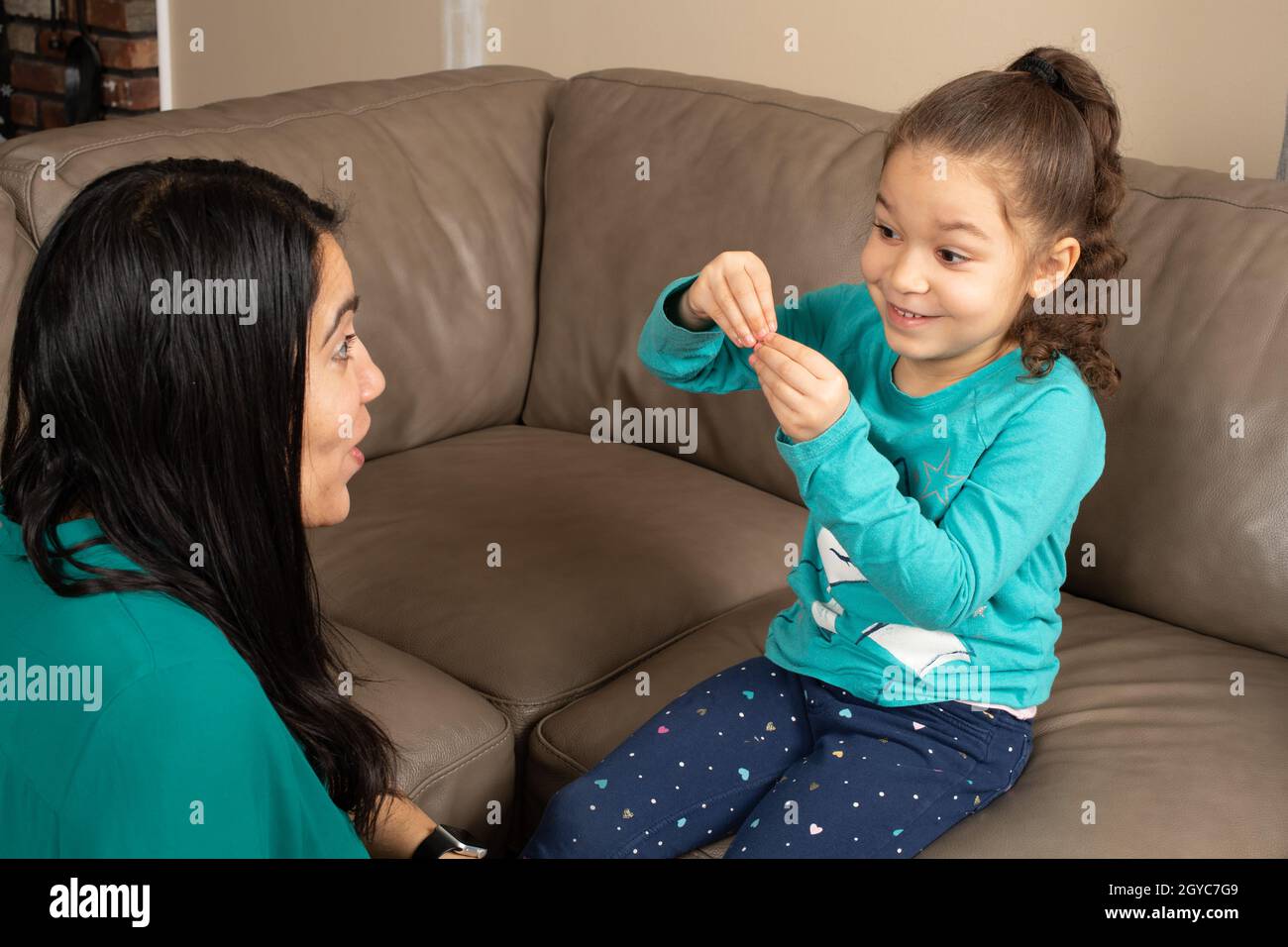 Five year old girl talking to her mother at home Stock Photo - Alamy