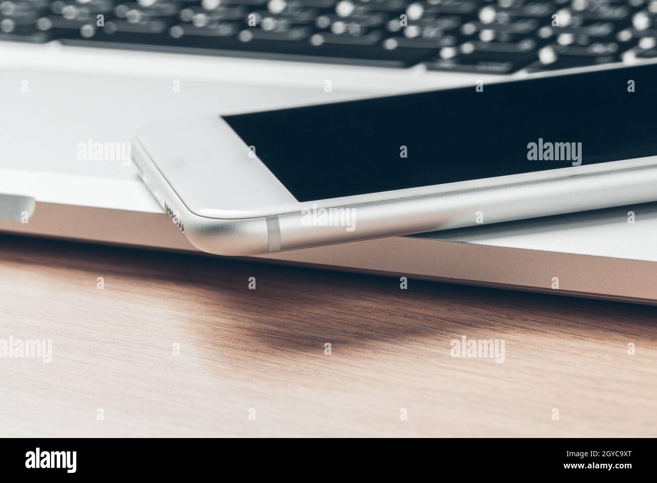 Laptop and mobile phone on the table. Workspace concept Stock Photo - Alamy
