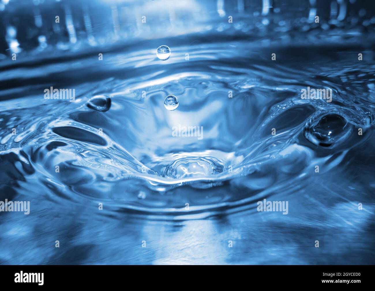 Water drops falling onto the surface Stock Photo - Alamy