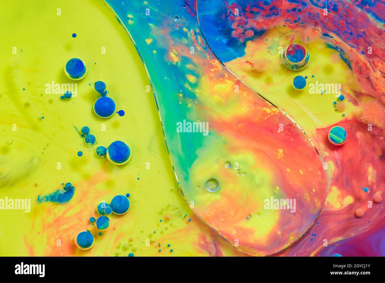 Unusual liquid surface of rainbow colors and orbs of blue Stock Photo ...