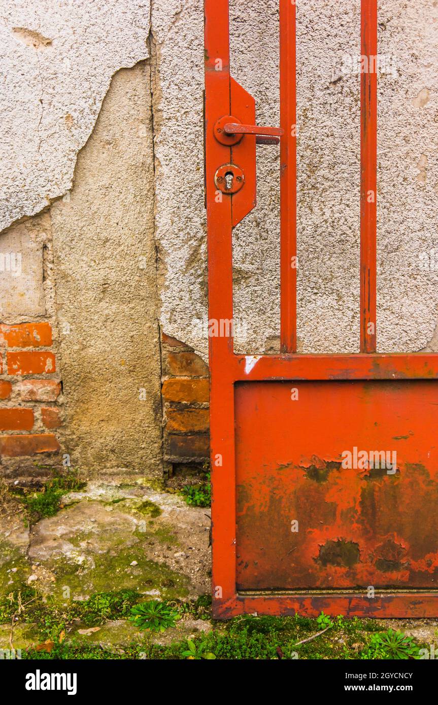 Poland, a view of an old half-painted gate without a lock against the ...