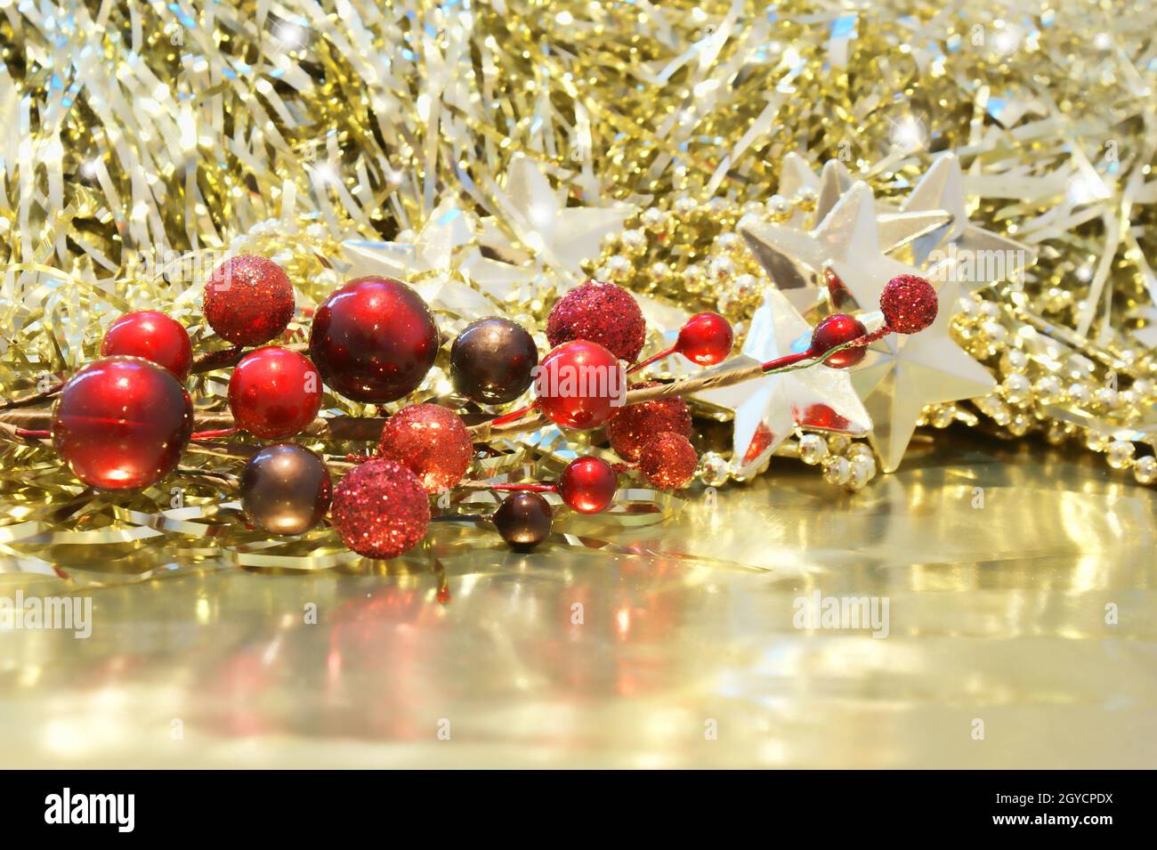 Christmas background with berries on a gold background Stock Photo - Alamy
