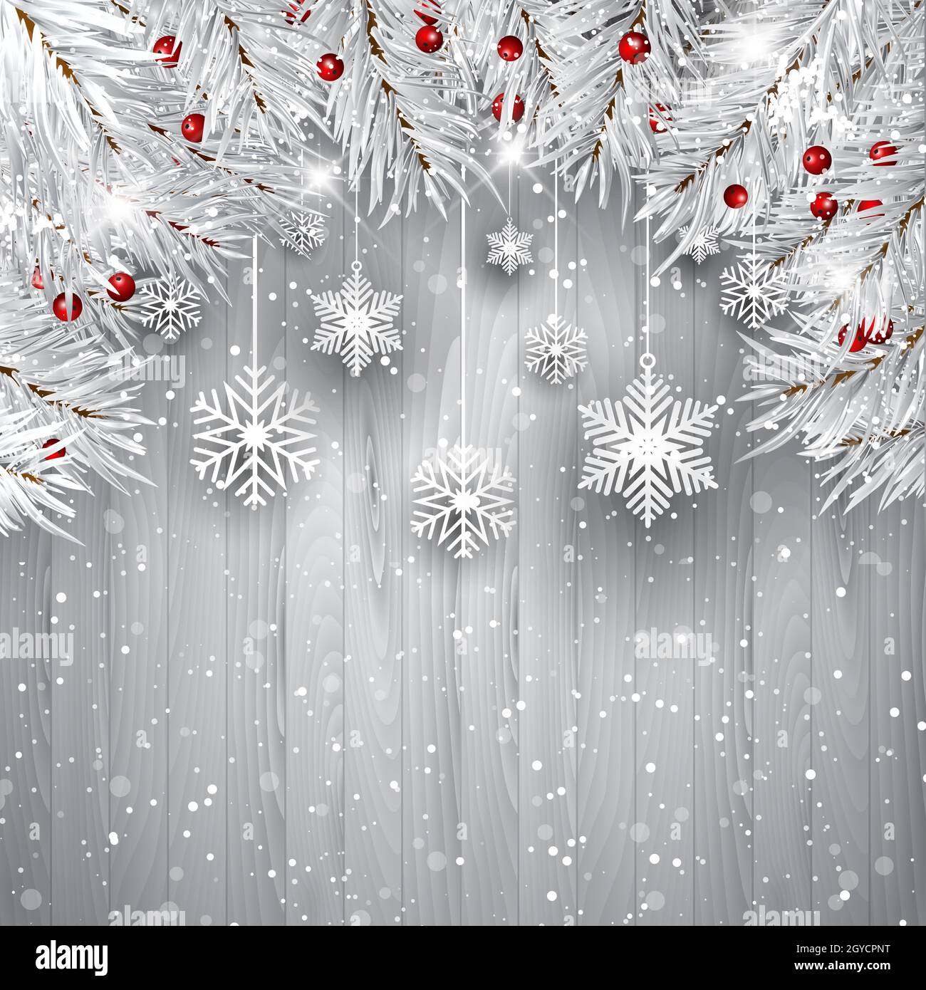 Hanging snowflakes with silver Christmas tree branches on a wooden ...