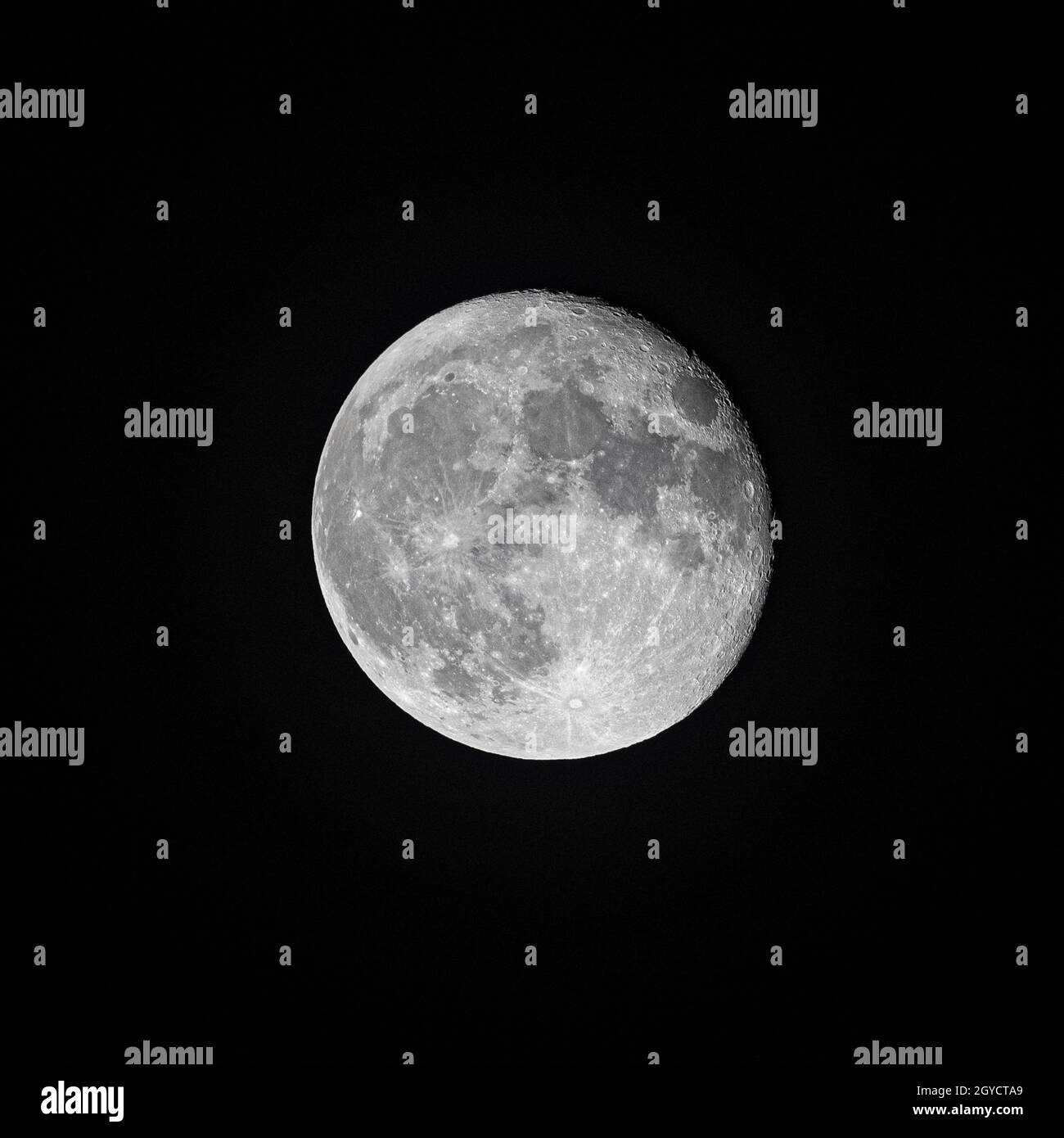 A bright full moon isolated in the black night sky Stock Photo - Alamy