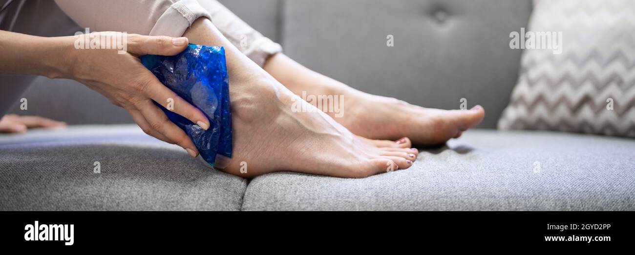 Leg Injury. Icing Ankle With Cold Pack And Ice Stock Photo - Alamy