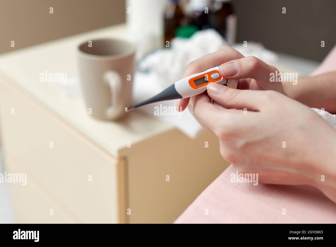 woman measures temperature with thermometer . close-up Stock Photo - Alamy