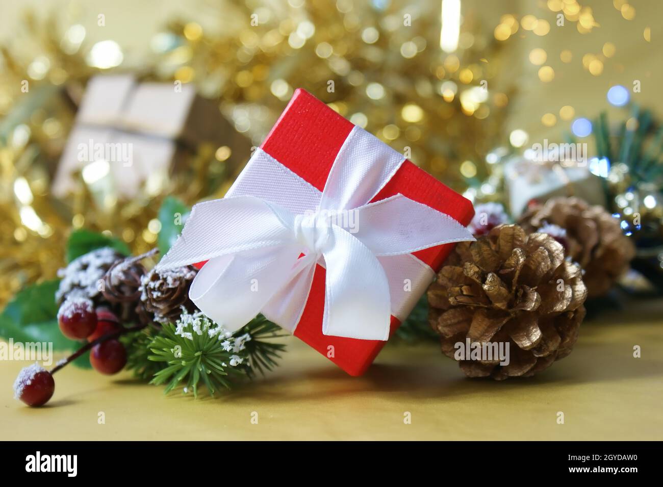 Luxurious red Christmas gift box on gold bokeh lights background Stock Photo - Alamy
