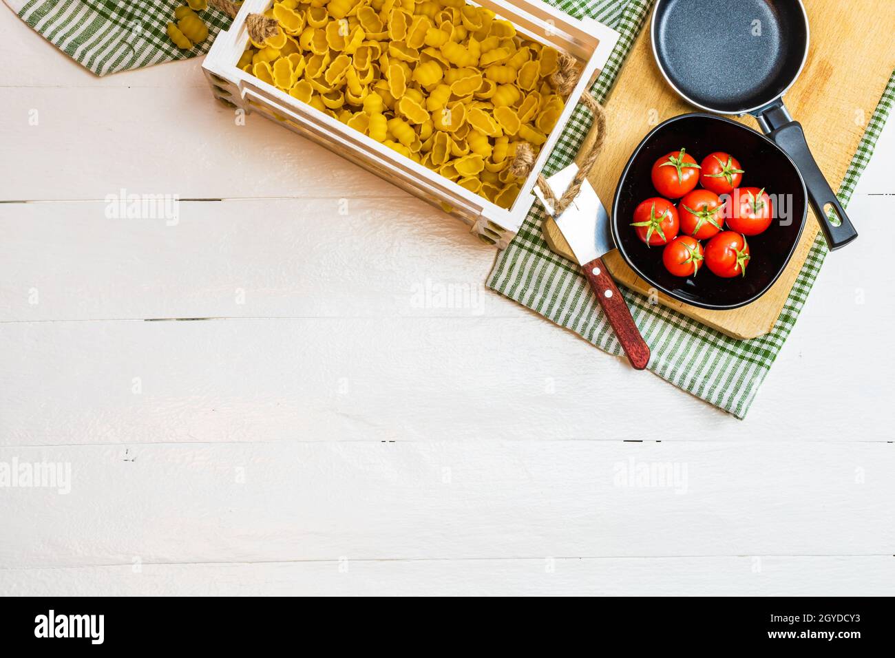 Beautiful tasty Italian pasta, tomatoes, onions and garlic for cooking ...