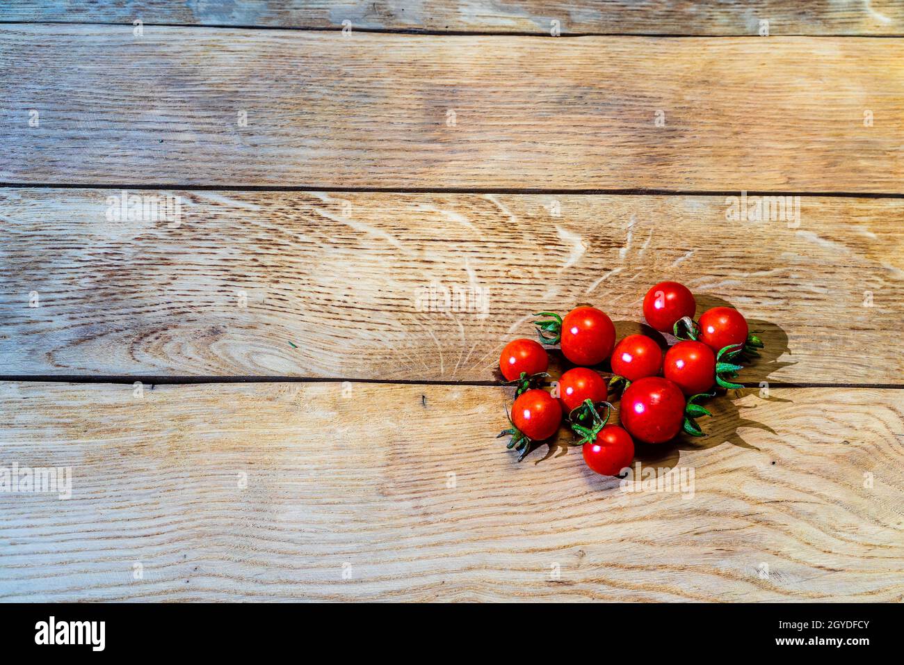 Cherry tomato on wooden table Stock Photo - Alamy