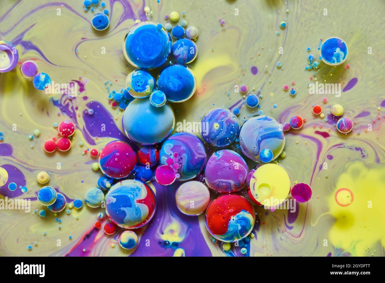 Colorful orbs floating on purple and yellow silky surface Stock Photo ...