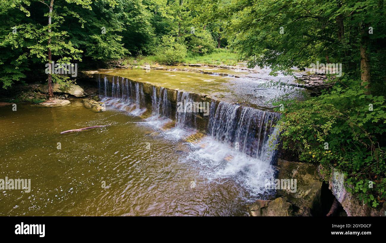 Long stretch of waterfalls over cliff in river buried in the forest ...
