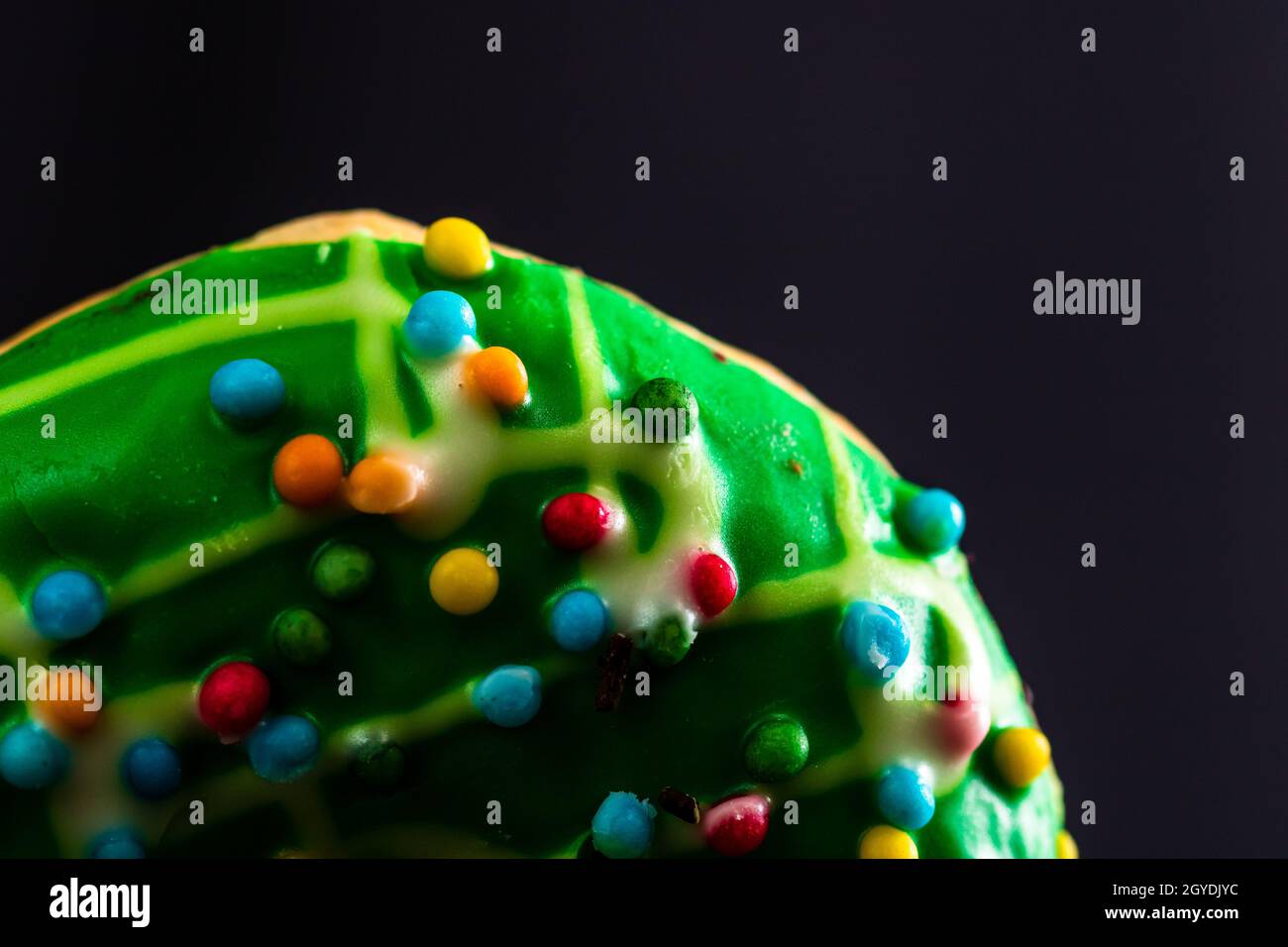 Green glazed donut with sprinkles isolated. Close up of colorful donut Stock Photo - Alamy