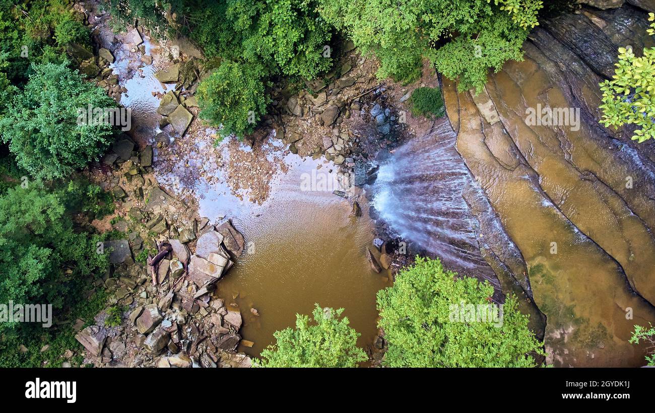 Waterfalls flowing into gorge from above surrounded by woods Stock ...