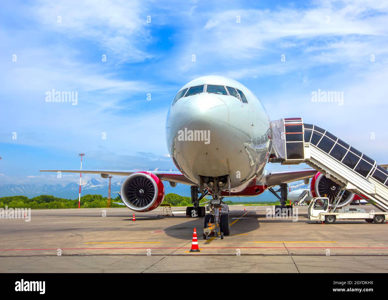 The Airplane with a passenger boarding steps on the airport apron Stock ...