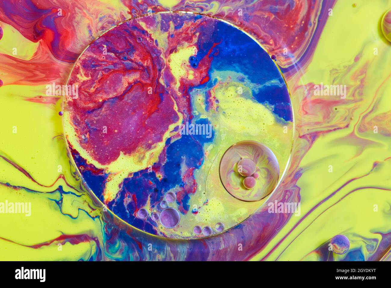 Red, yellow, and blue colors on liquid surface with tiny orbs and ...
