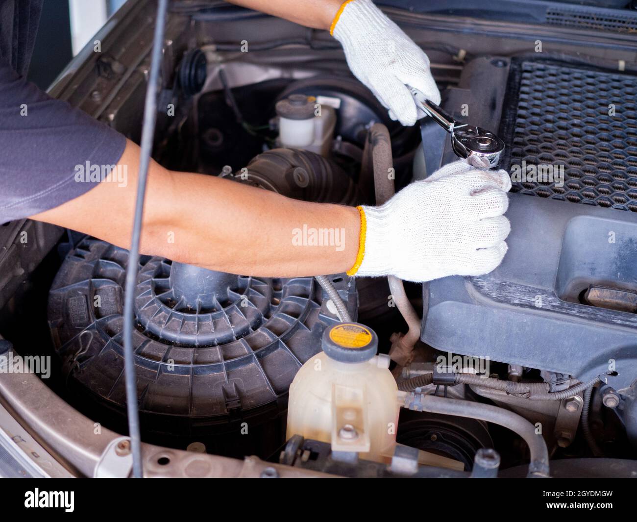 Mechanic holding a block wrench handle while fixing a car Stock Photo ...
