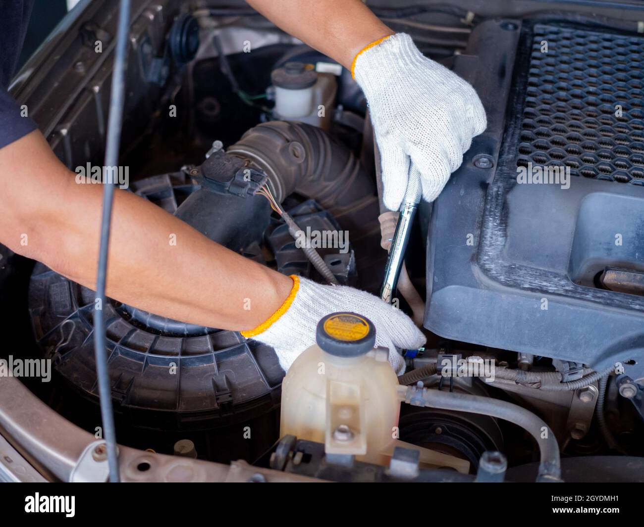 Mechanic holding a block wrench handle while fixing a car Stock Photo ...