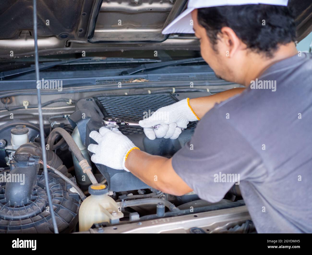 Mechanic holding a block wrench handle while fixing a car Stock Photo ...
