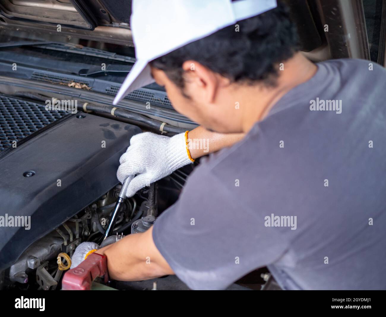 Mechanic holding a block wrench handle while fixing a car Stock Photo ...