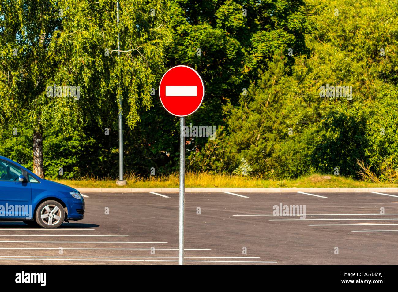 No entry road sign with lonely car on the parking lot Stock Photo - Alamy