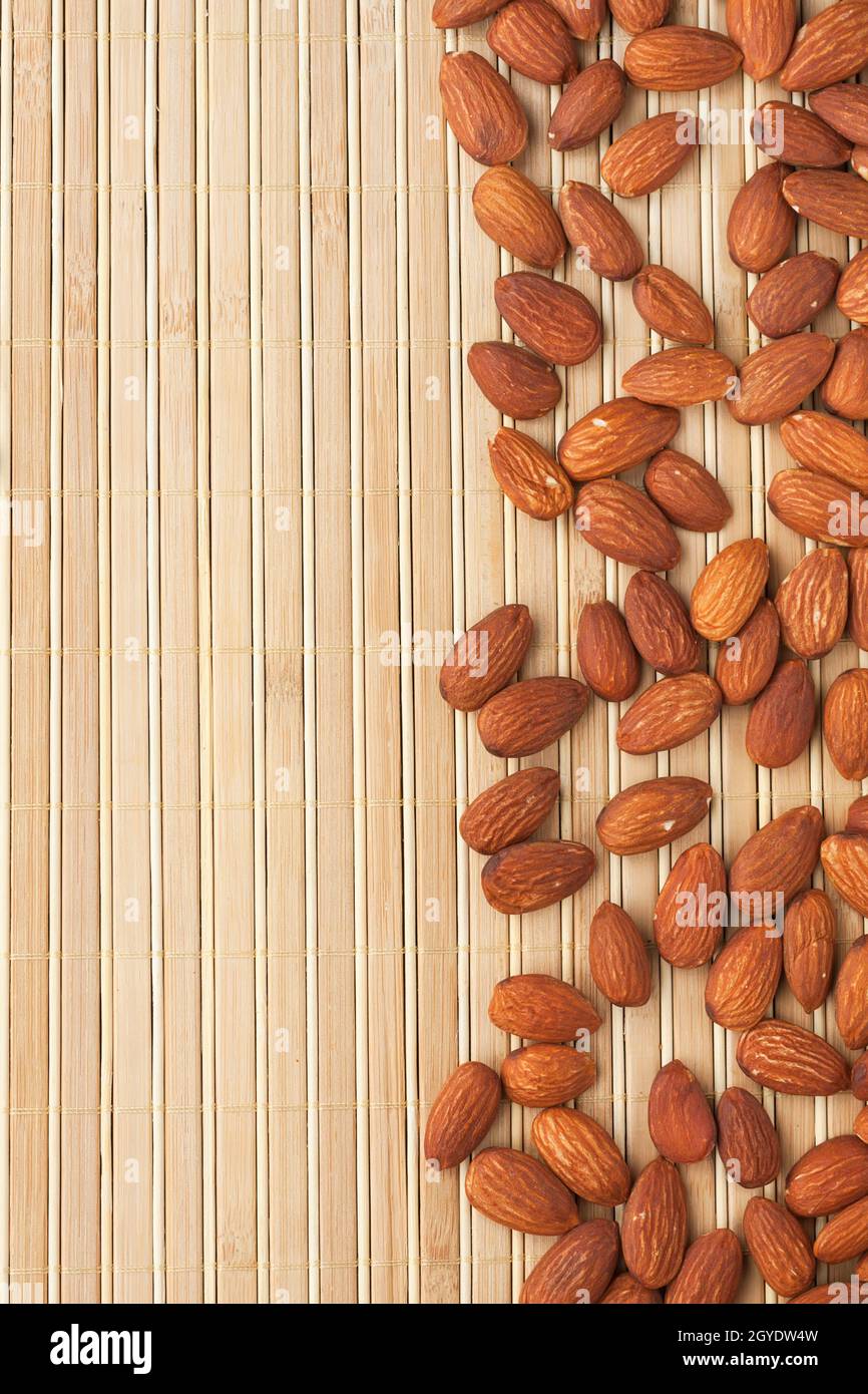 almond lying on a bamboo mat can be used as background Stock Photo - Alamy