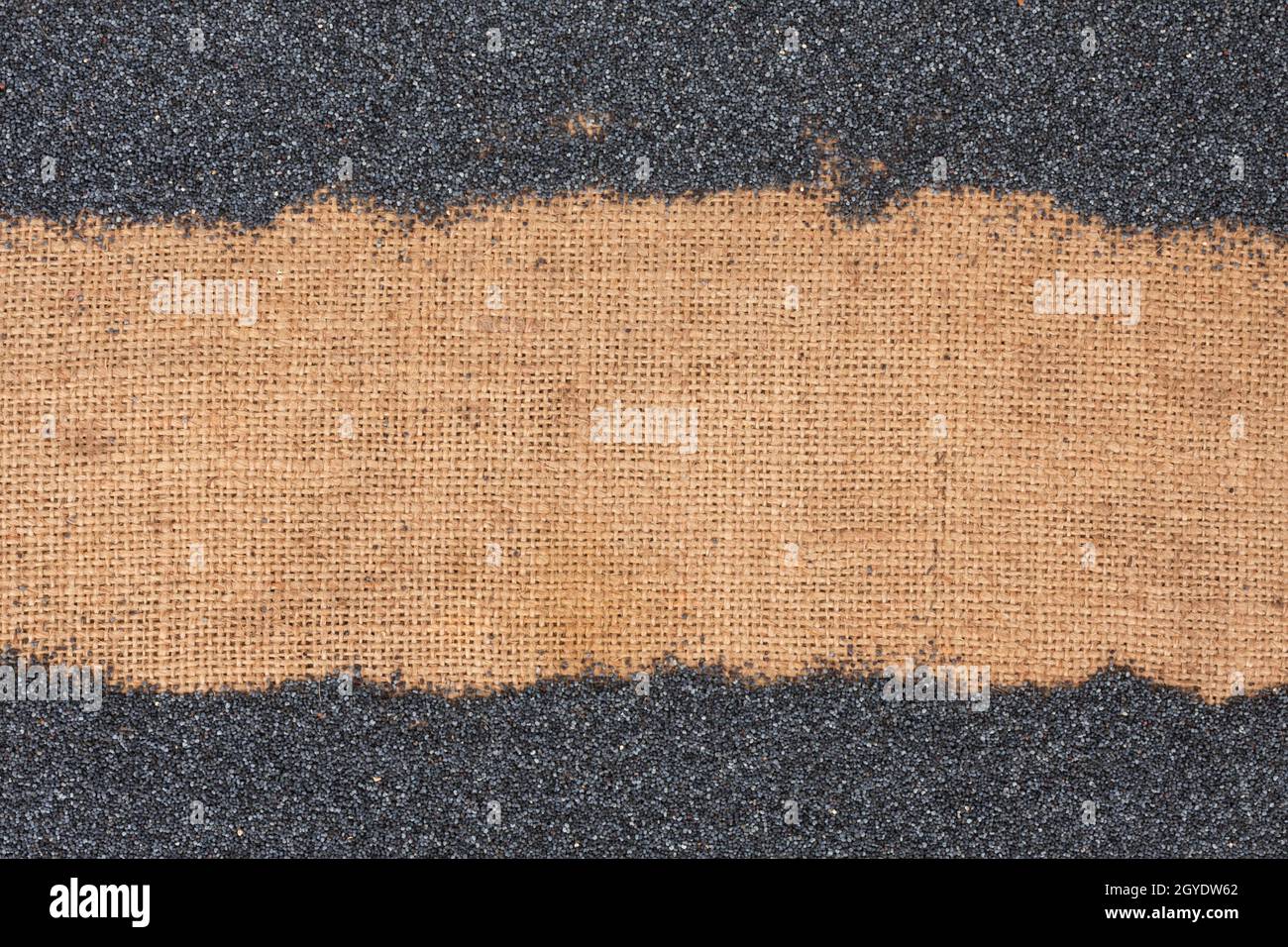 Poppy lying on sackcloth space for text Stock Photo - Alamy