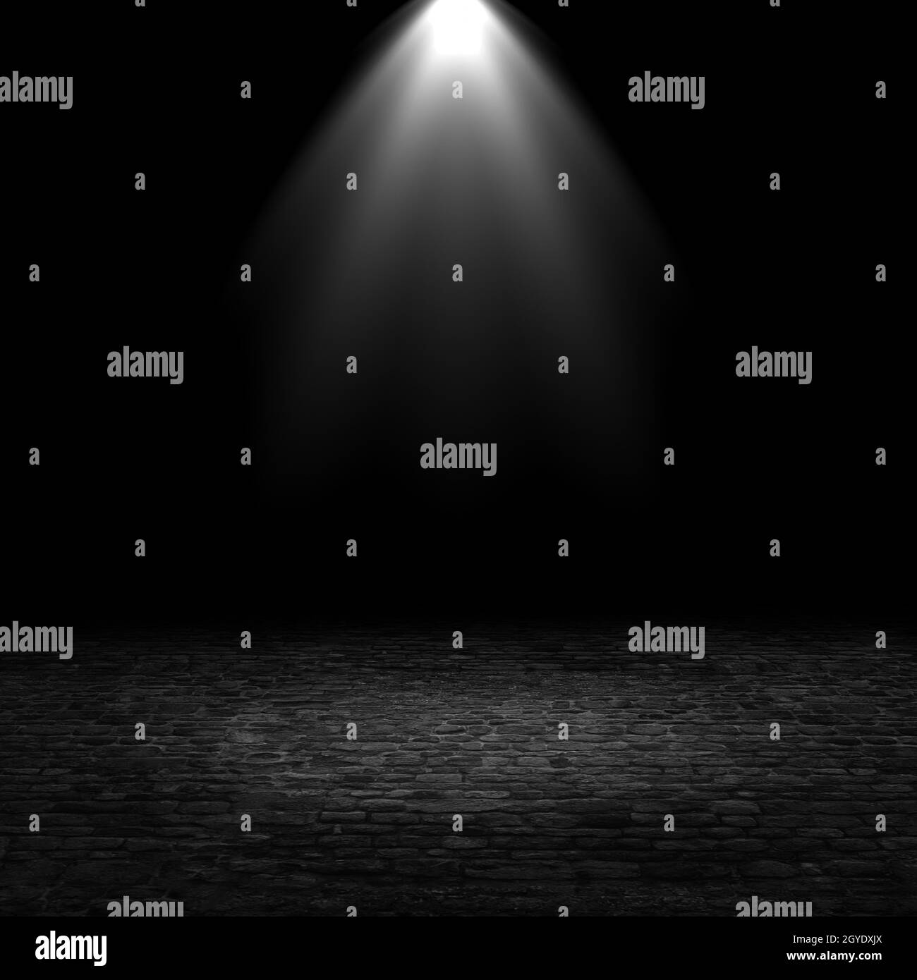 3D render of a spotlight shining down into a grunge interior with brick ...