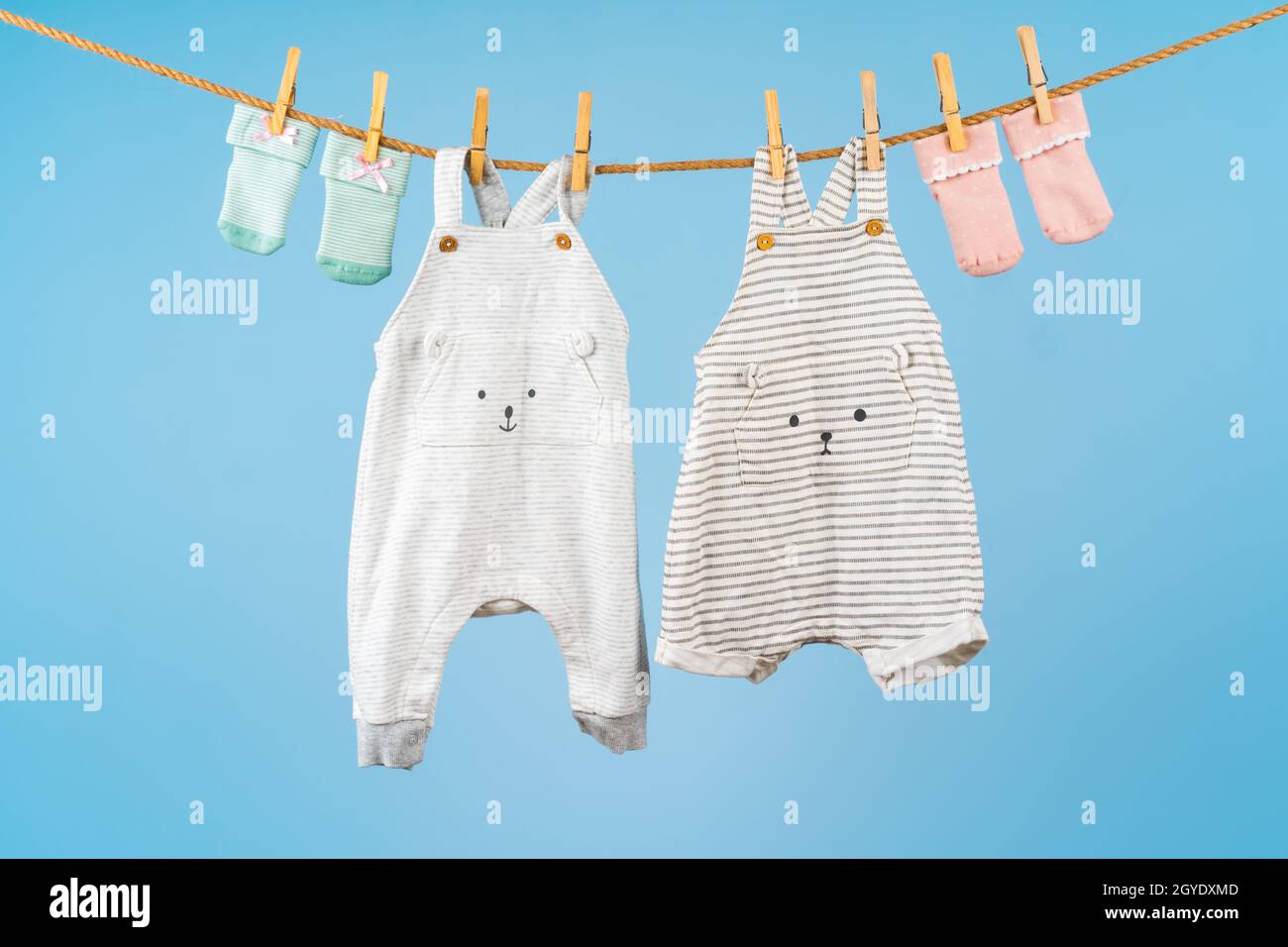 Cute toddler colorful clothing hang on a rope Stock Photo - Alamy