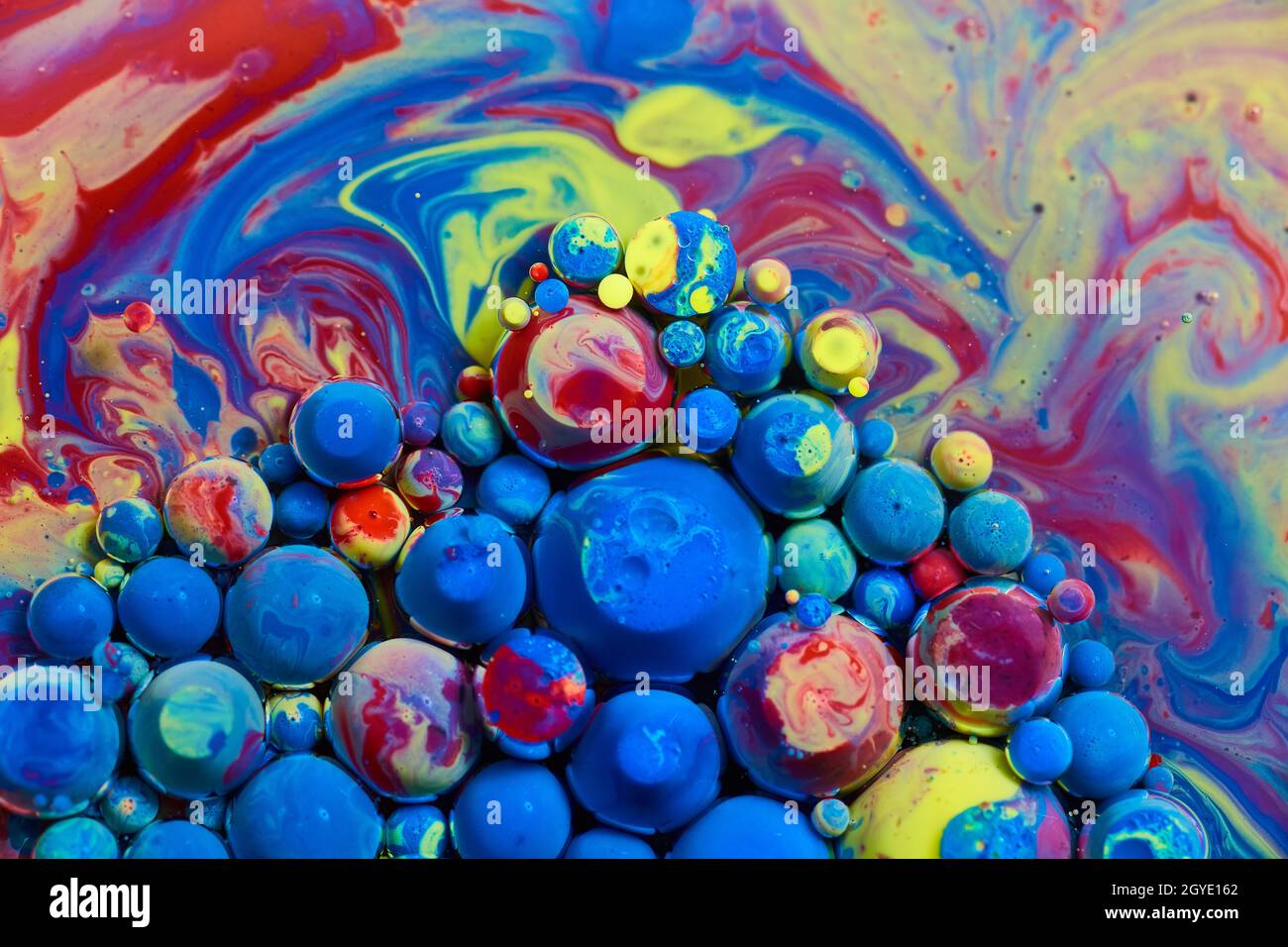 Cluster of acrylic paint orbs floating on rainbow surface Stock Photo ...