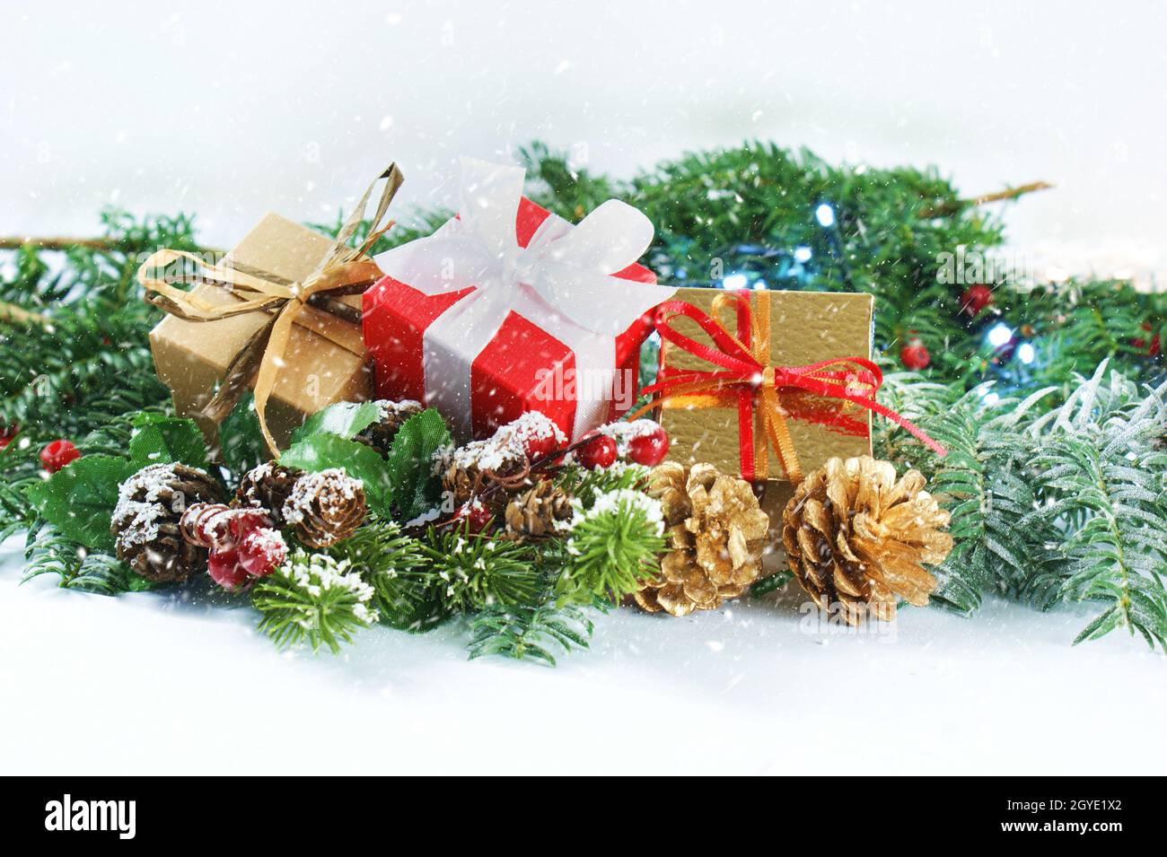 Christmas gifts and decorations with snow overlay Stock Photo - Alamy