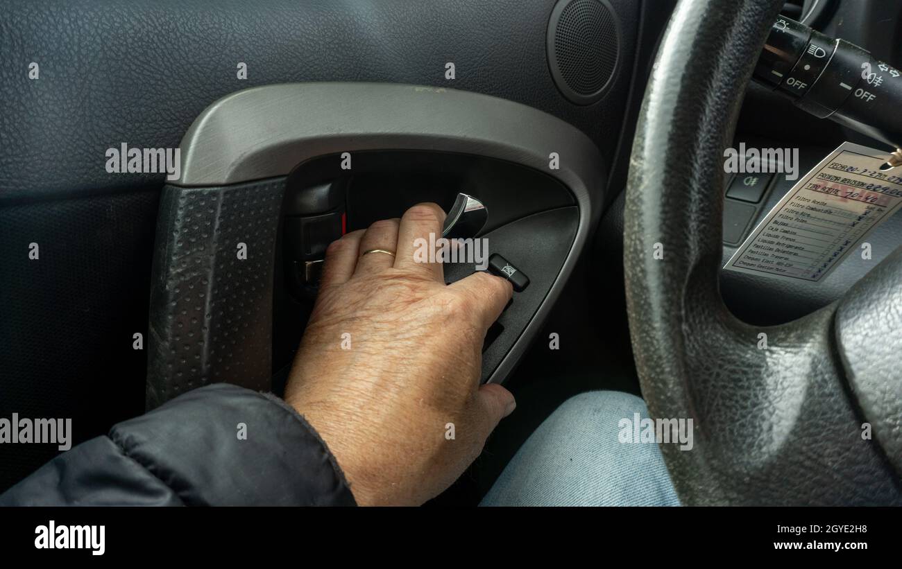 hand on the opening device inside a car to open the door and exit Stock ...