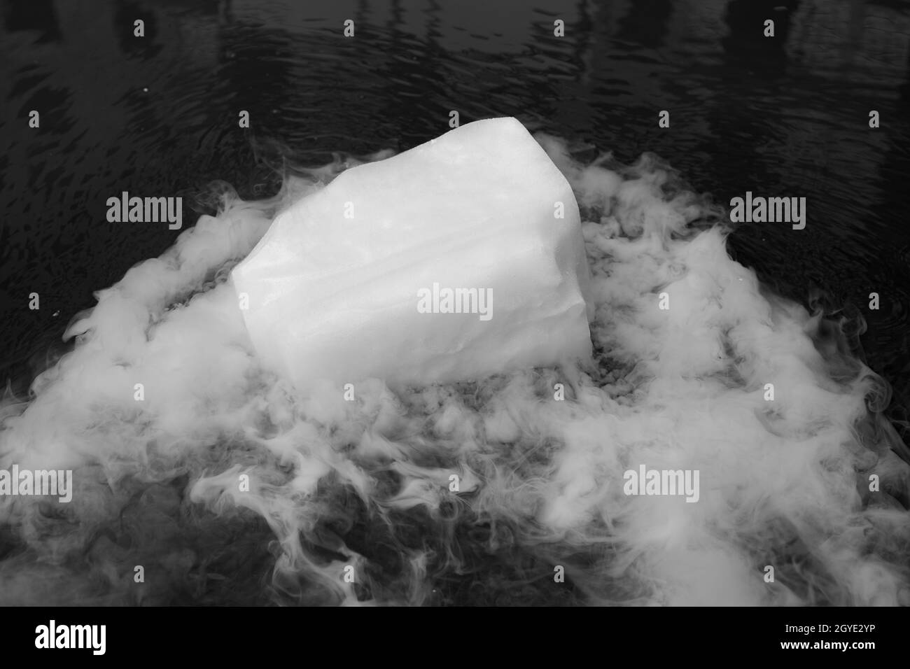 Dry ice evaporates in the water. Steam from a large piece of ice ...
