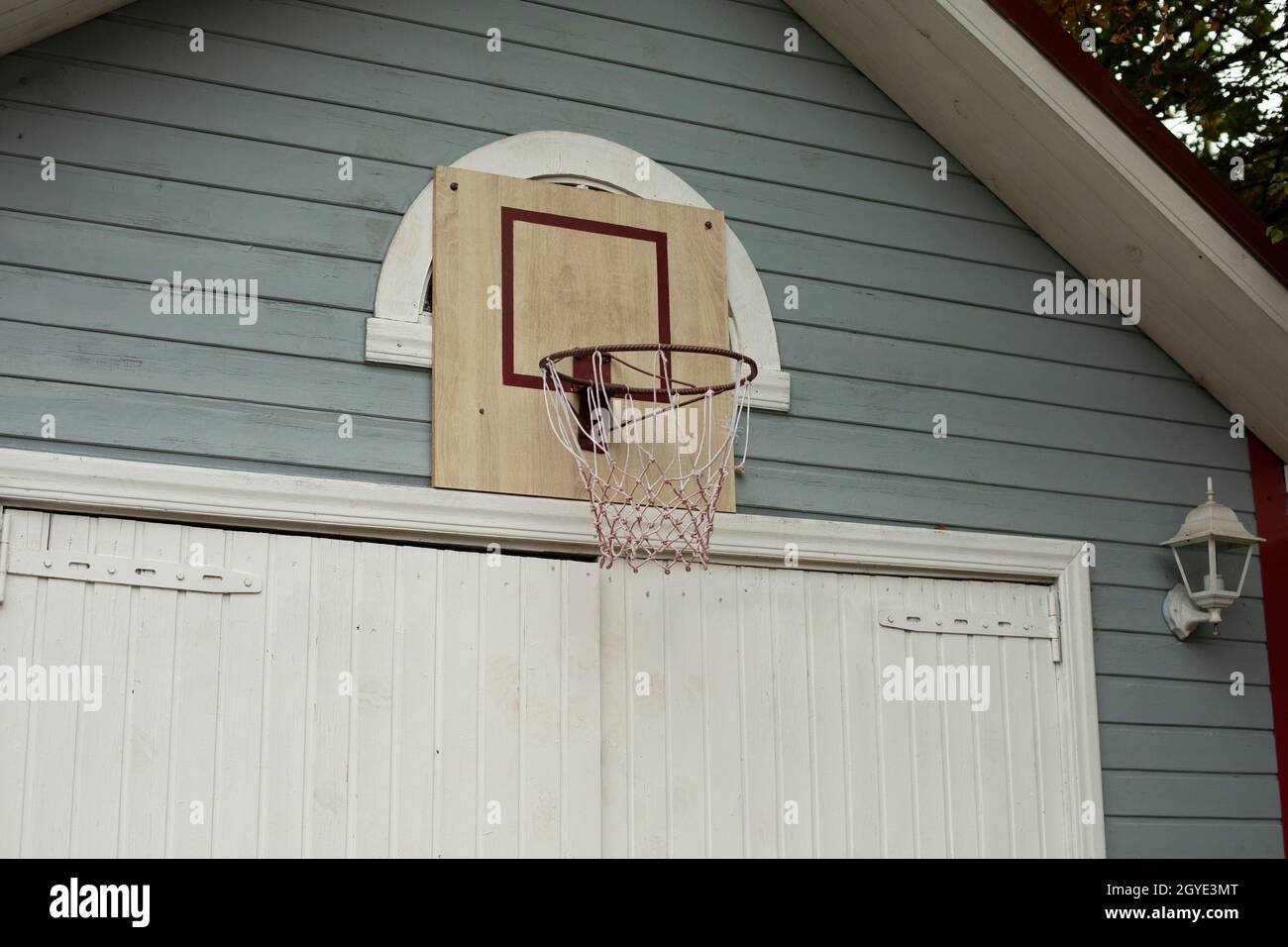 Basketball hoop in the yard of the house. Sports equipment. House for ...
