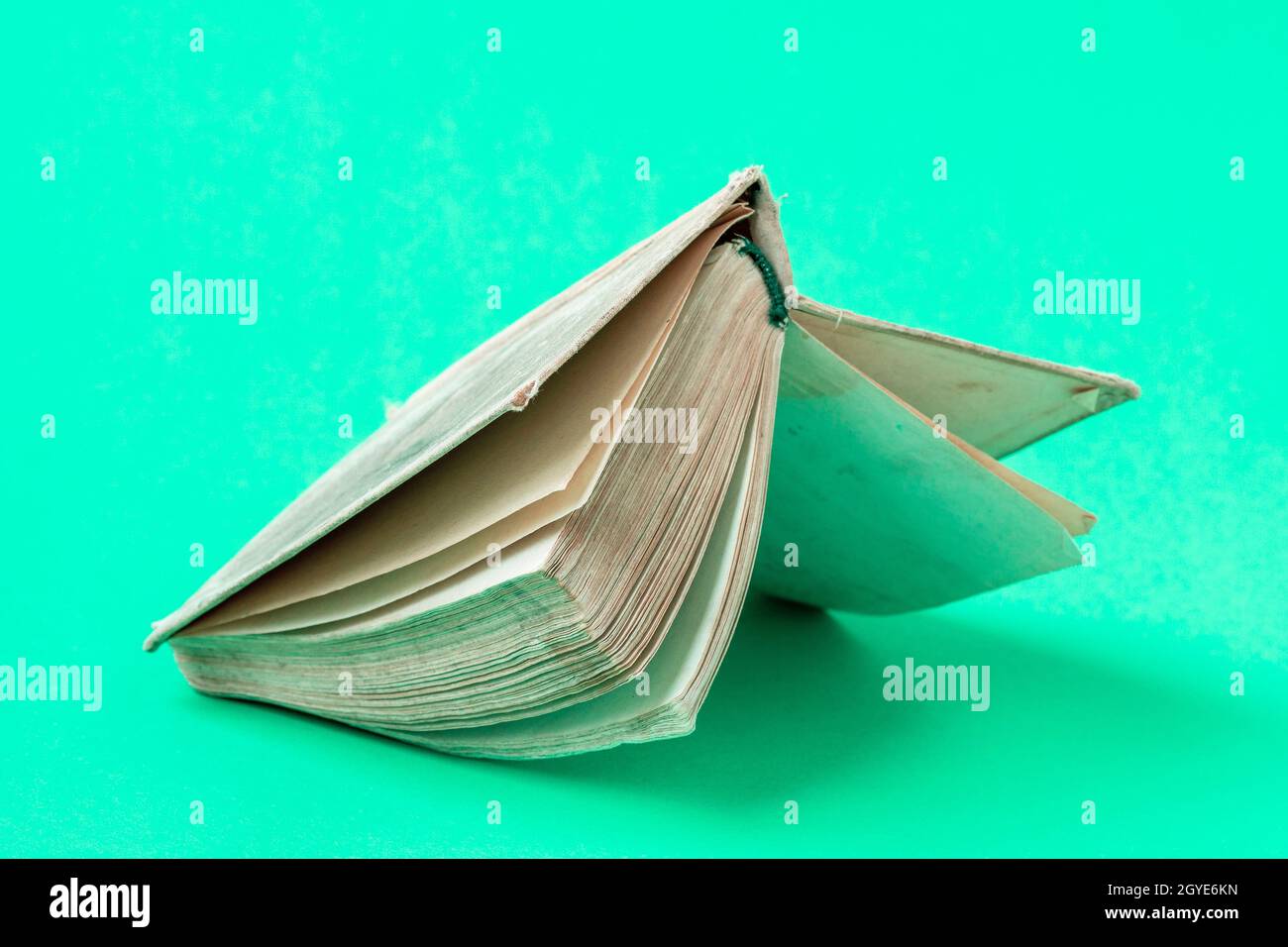 Falling antique old book with moving pages on blue background Stock ...