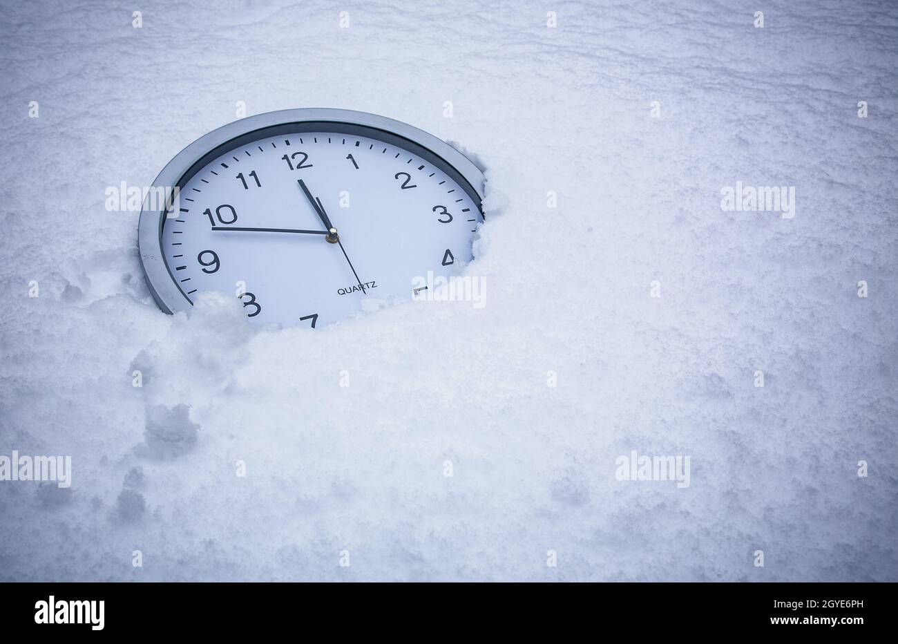 Emergency clock in the snow for climate change Stock Photo - Alamy