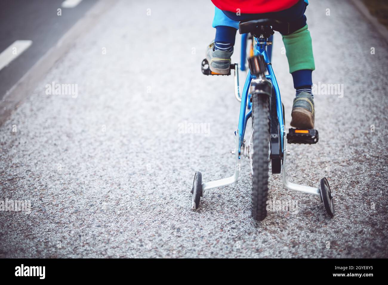 Little boy on the bicycle on the road in the city. Concept of the ...