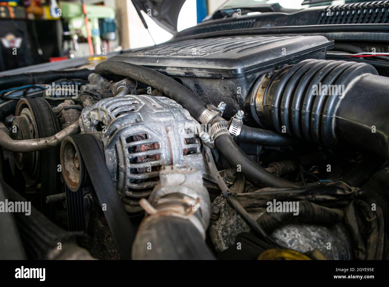 Car engine alternator detail in a mechanical workshop Stock Photo - Alamy