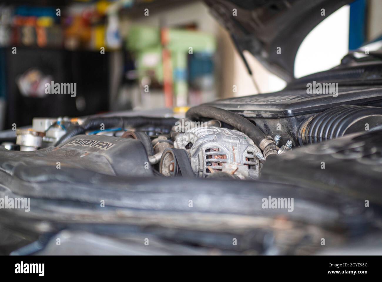 Car engine alternator detail in a mechanical workshop Stock Photo - Alamy