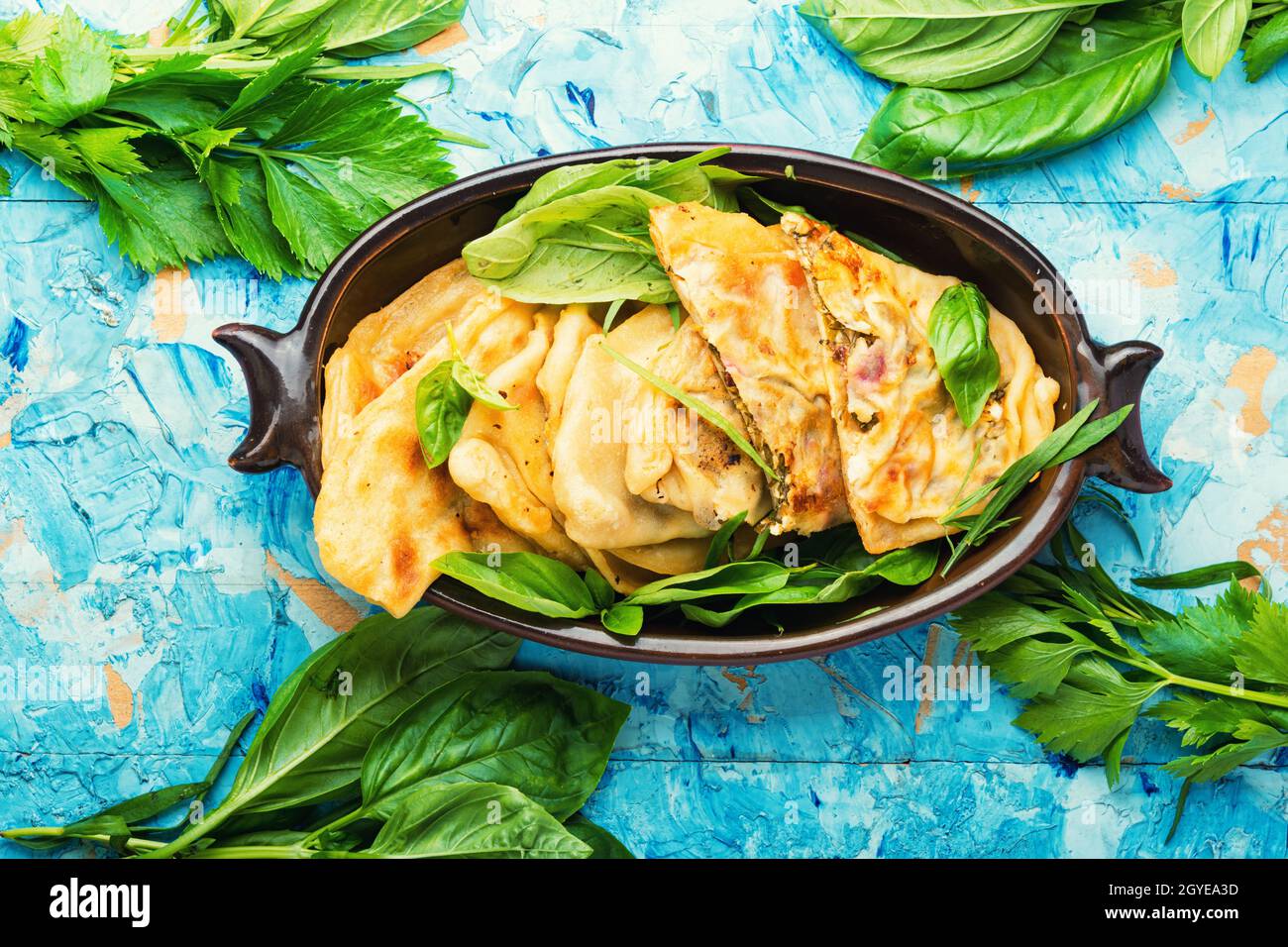 Unleavened dough pie stuffed with fresh herbs. Qutabs or kutab ...