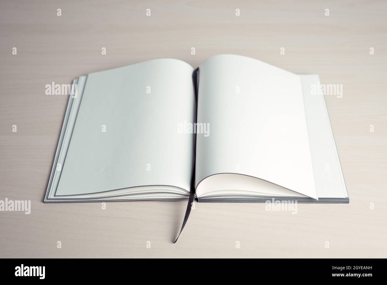 Opened book with blank pages on top of wooden table Stock Photo - Alamy
