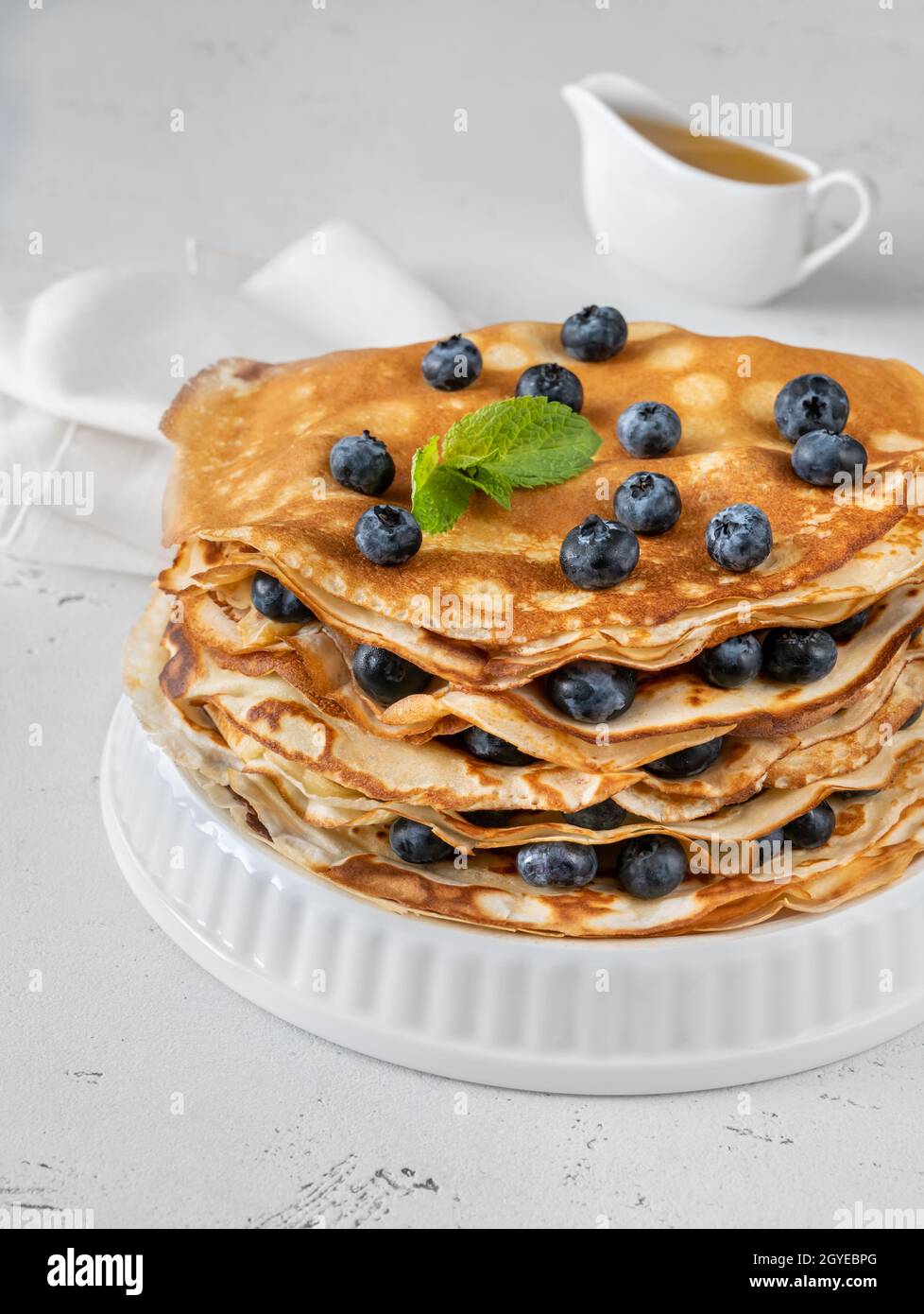 Stack of crepes with fresh blueberries on white background Stock Photo ...