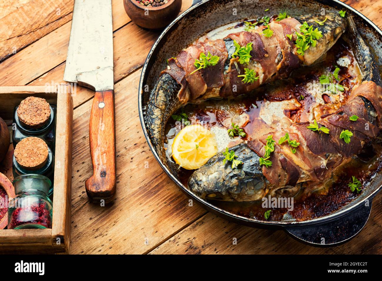 Baked fish wrapped in bacon, fried pelengas Stock Photo - Alamy