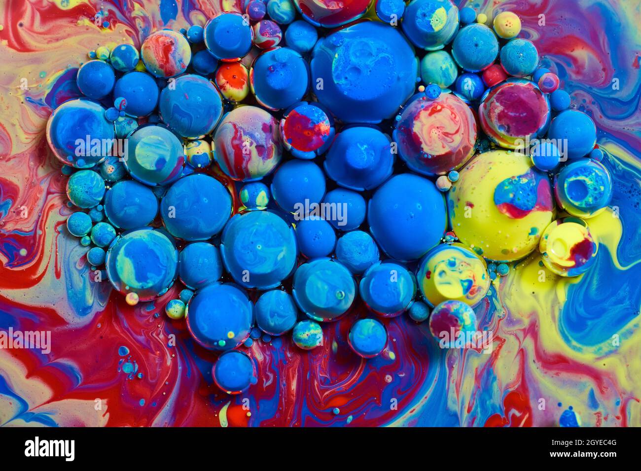 Tiny blue spheres and rainbow spheres floating on surface Stock Photo ...