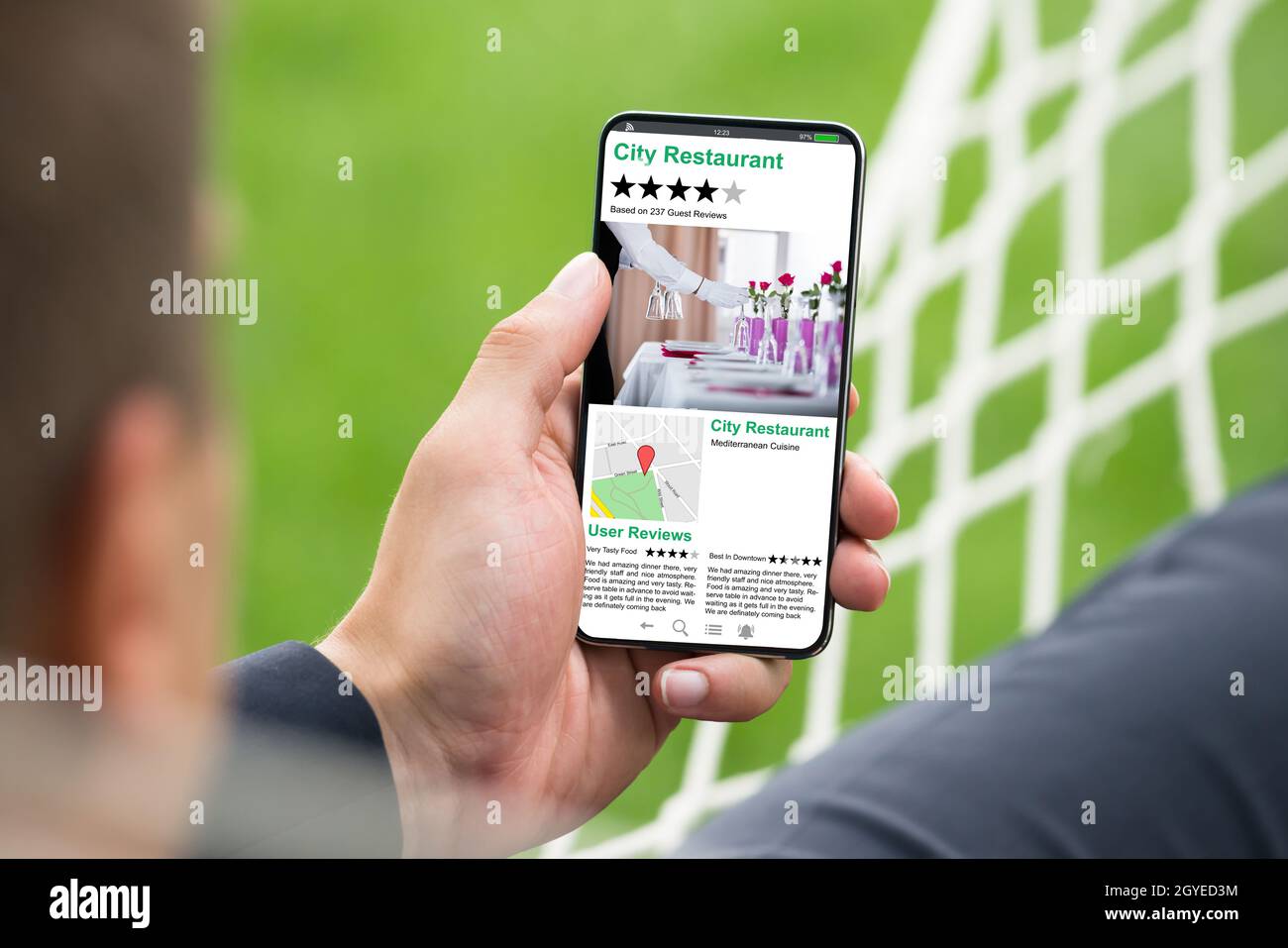 Man Holding Phone With Online Reviews And Feedback Stock Photo - Alamy