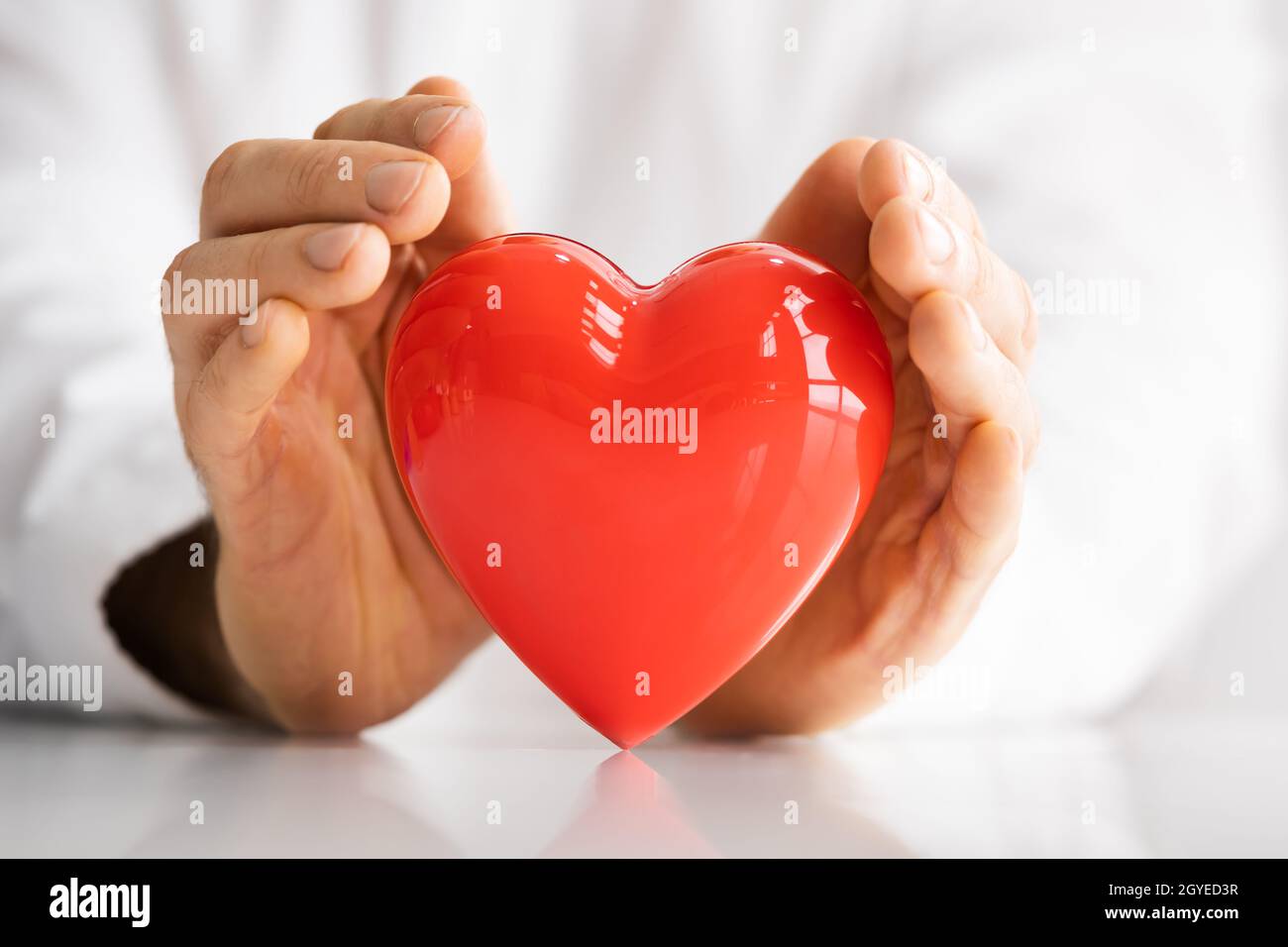 Doctor Hand Protecting Heart. Health Insurance And Charity Stock Photo ...
