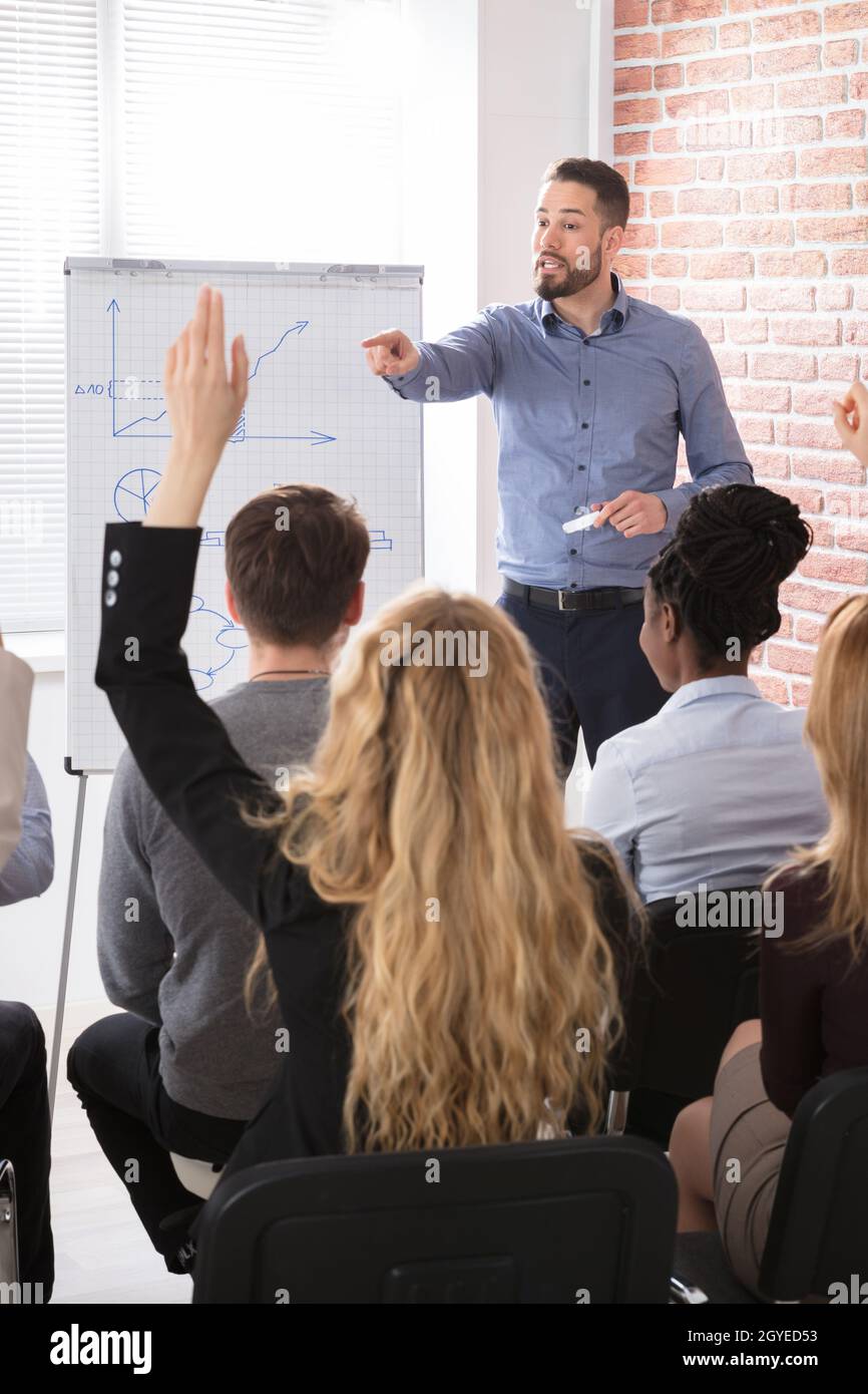 Corporate Business Team Meeting In Classroom Asking Question Stock