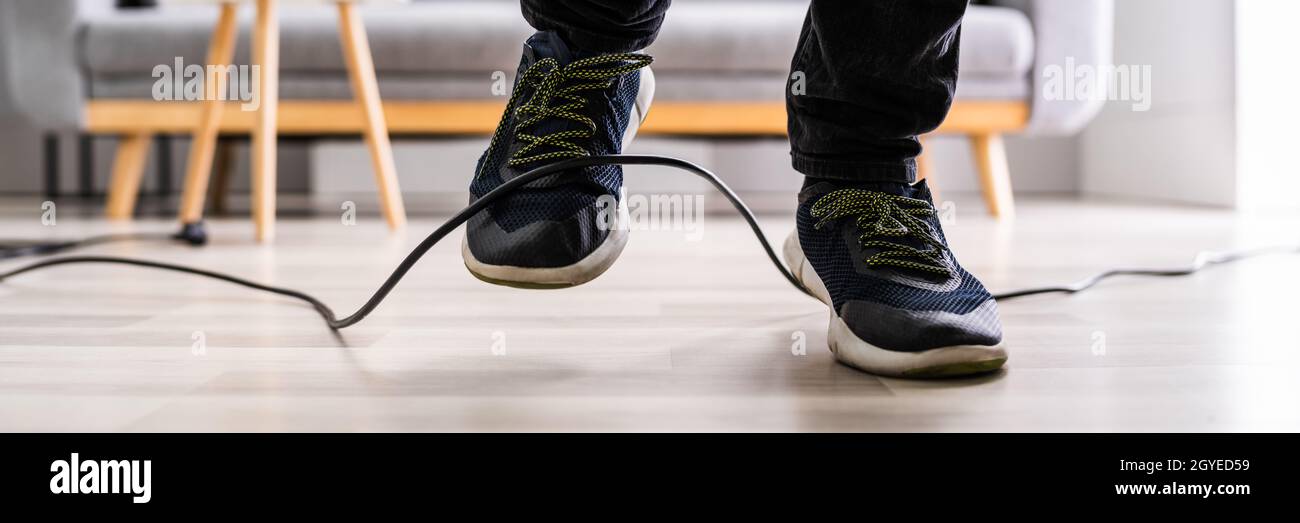 Wire Cord Trip Over And Fall. Feet Stumble On Cable Stock Photo - Alamy